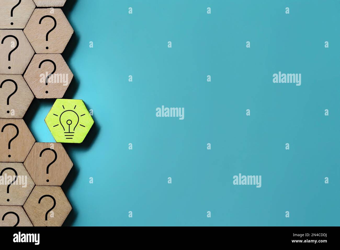 Question marks and glowing lightbulb with copy space for text. Looking ...