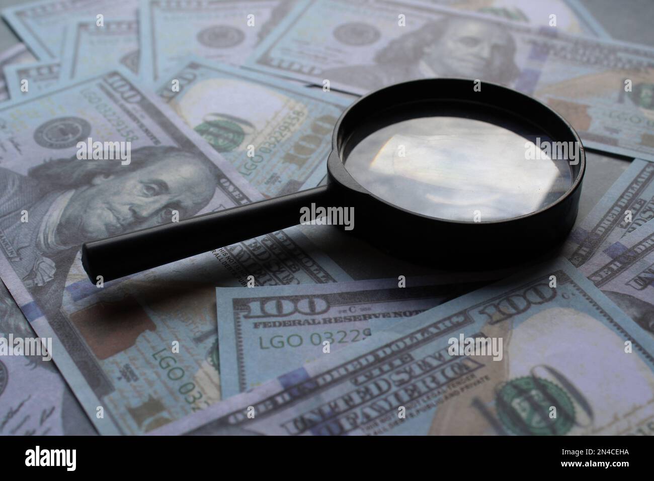 Money, United States dollar and magnifying glass. Business and ...