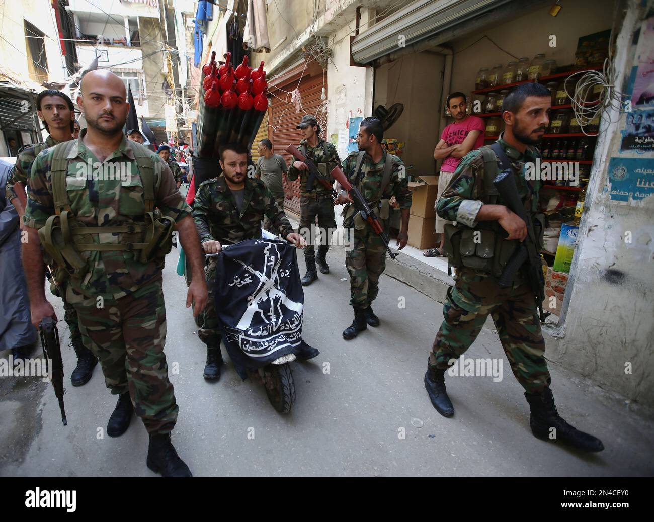 Palestinian gunmen with representations of missiles march during a ...