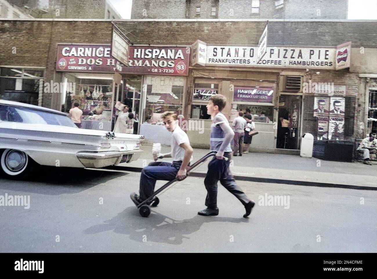Two Boys in Street, one riding on Hand Truck, New York City, New York ...