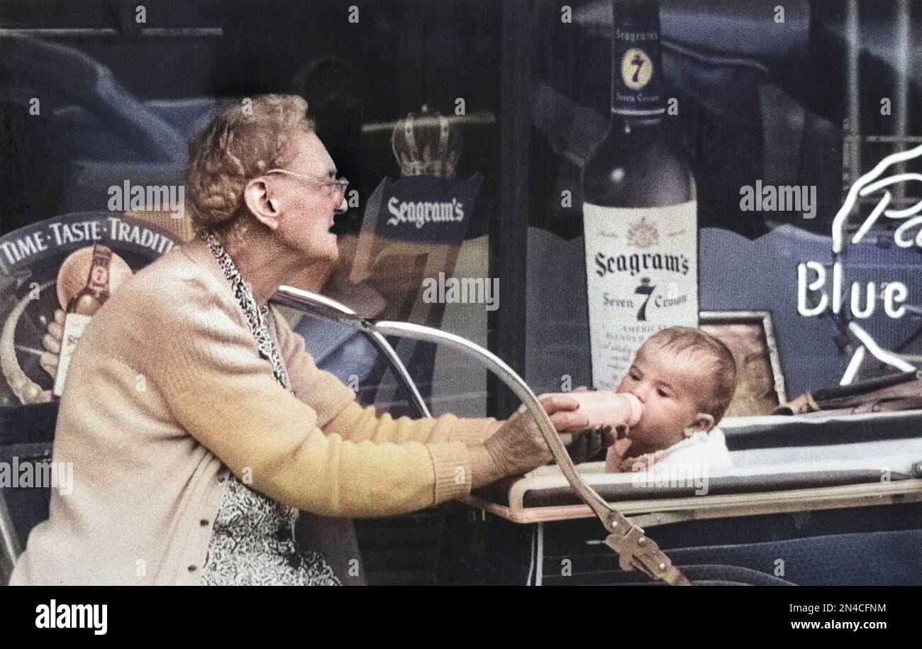 Elderly Woman feeding Baby in Baby Carriage, Signs for Seagram's in ...