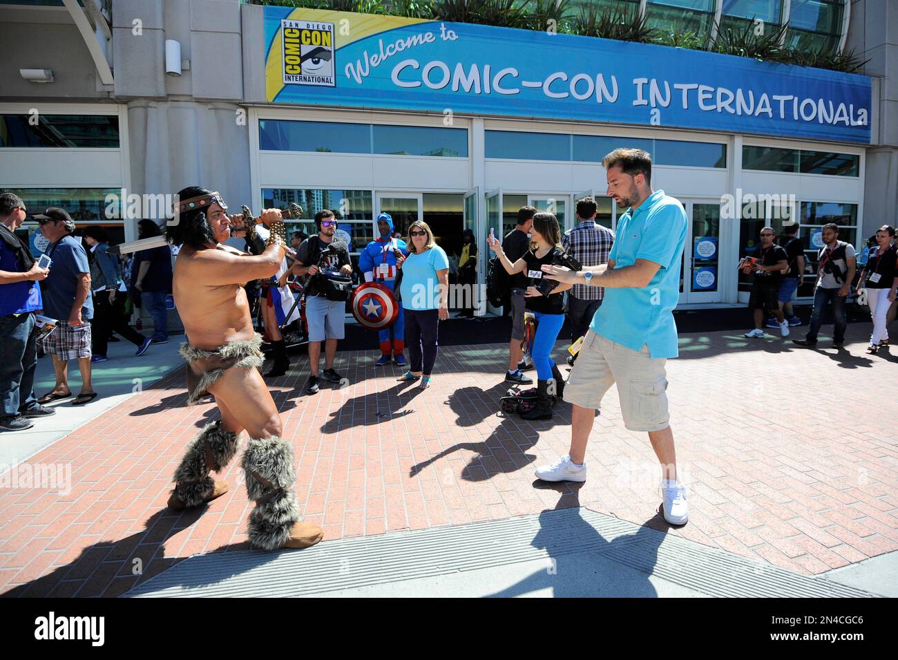 A sword wielding warrior works with a video crew outside the convention ...