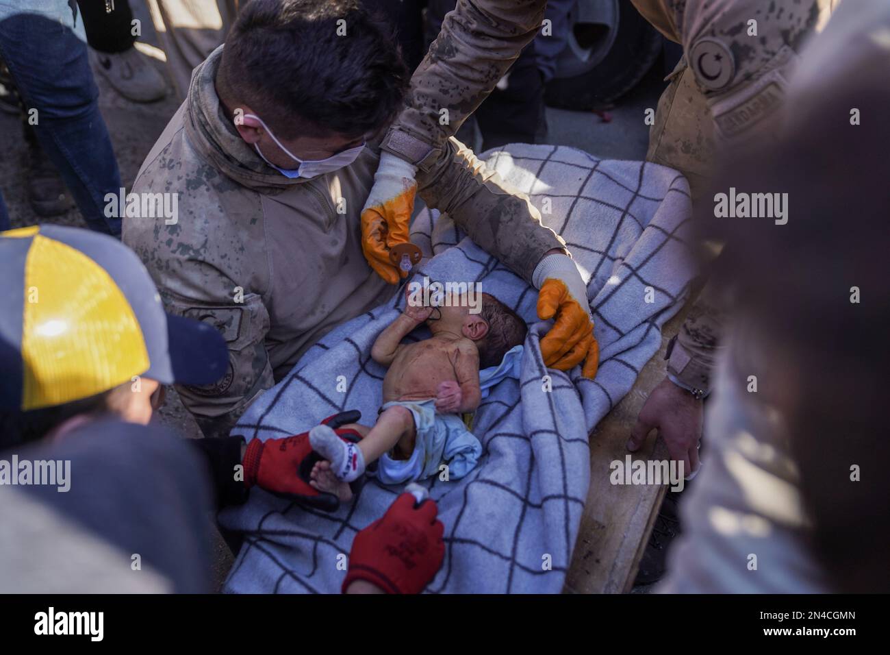 Hatay, Turkey. 08th Feb, 2023. Soldiers examine a 20-day-old baby who ...