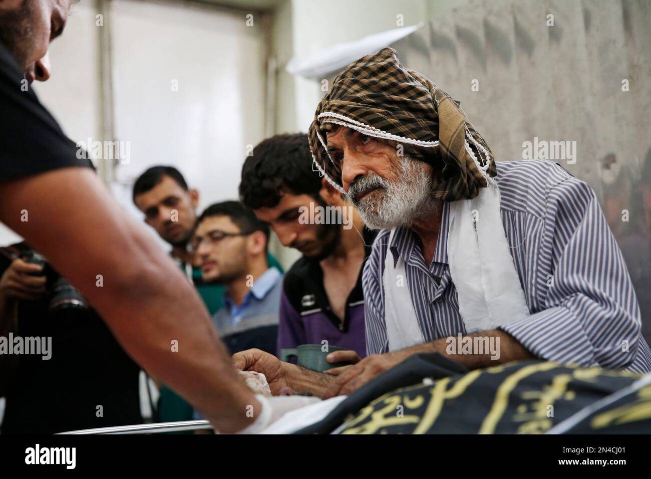 Palestinian Ahmed Jadallah, 75, prepares a body for burial at the ...