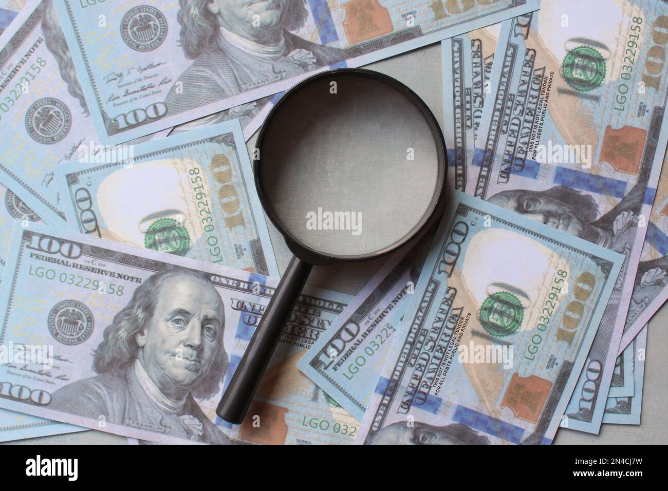 Magnifying dollar bill magnifying glass hi-res stock photography and ...