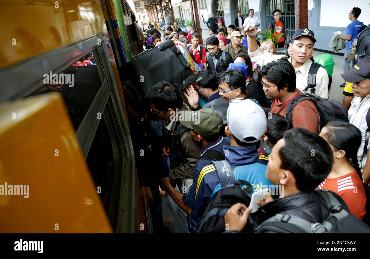 Passengers board a train at Senen station in Jakarta, Indonesia ...