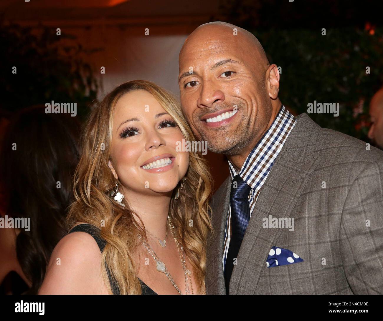 From left, Singer Mariah Carey and actor Dwayne Johnson attend the ...