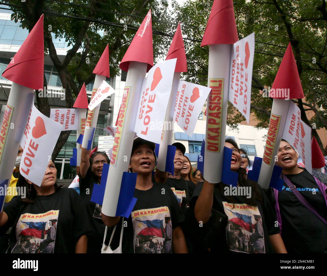 Protesters thrust mock missiles towards the Chinese Consulate at the ...