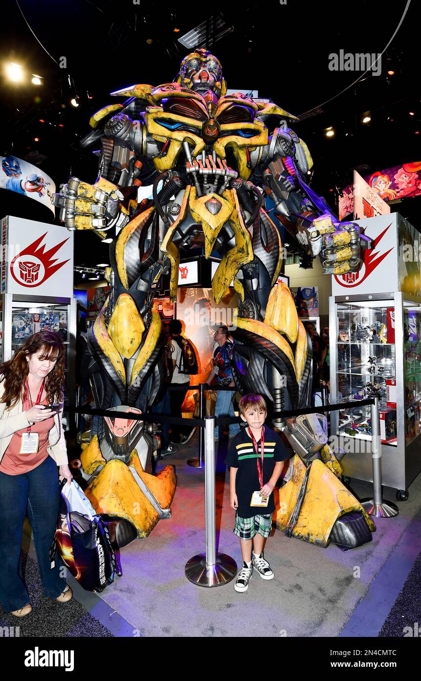 A young fan poses with a huge Transformers display during preview night ...
