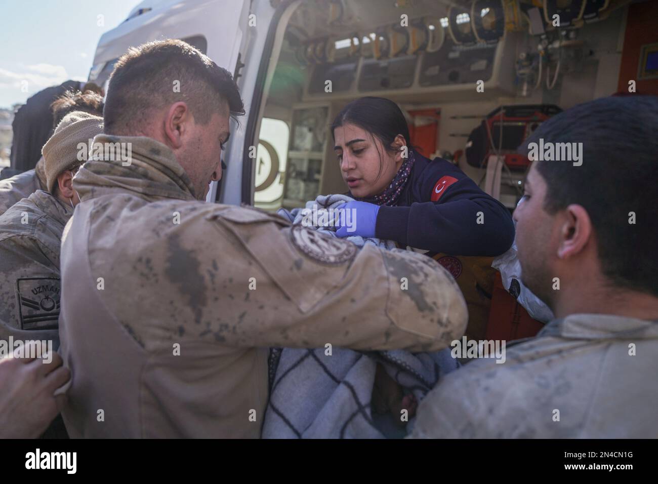 Soldiers carry a 20-day-old baby who was rescued 59 hours after the ...