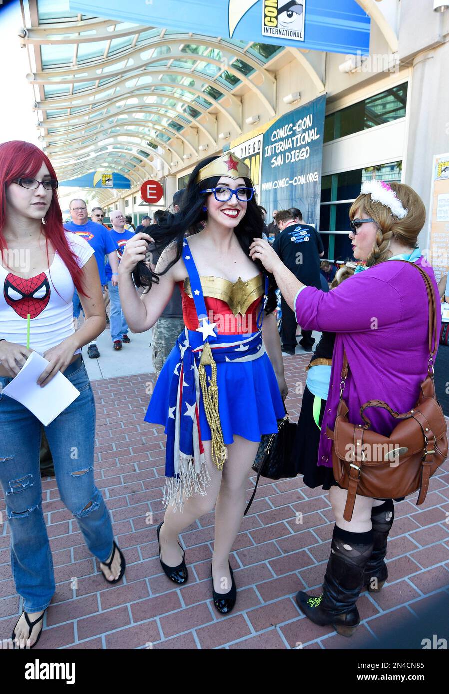 Dressed as Wonder Woman, Lindsay Stanley, center, has her costume ...