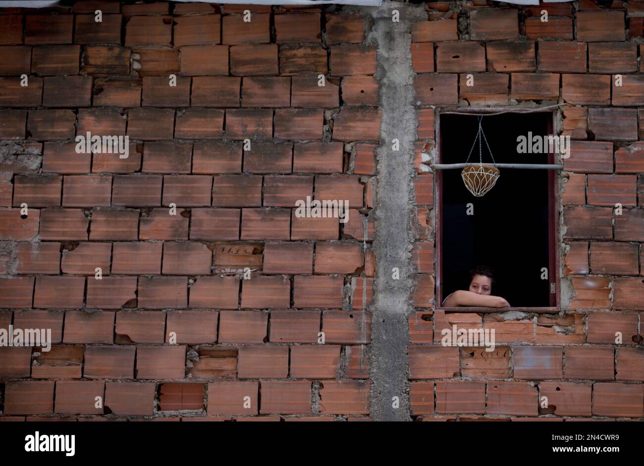 A woman looks from a window of her apartment at the world’s tallest ...