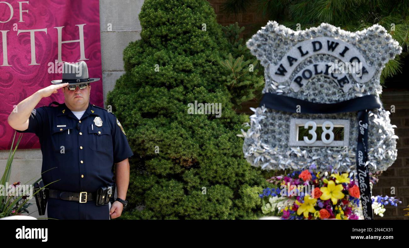 An officer salutes before funeral services for Waldwick Police officer ...