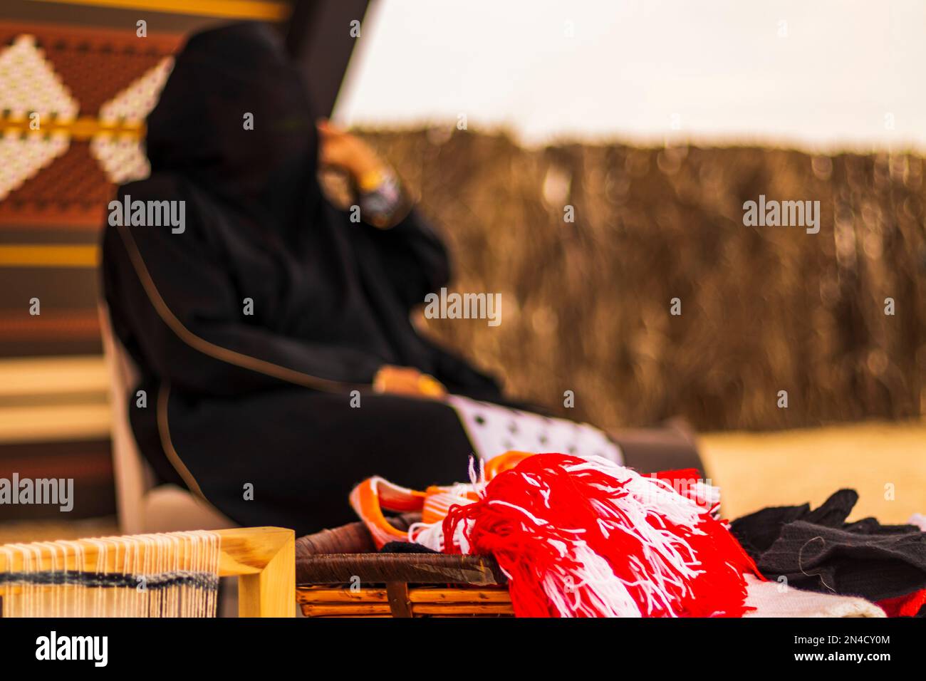 Photograph of an Arab woman sitting on the chair Stock Photo - Alamy