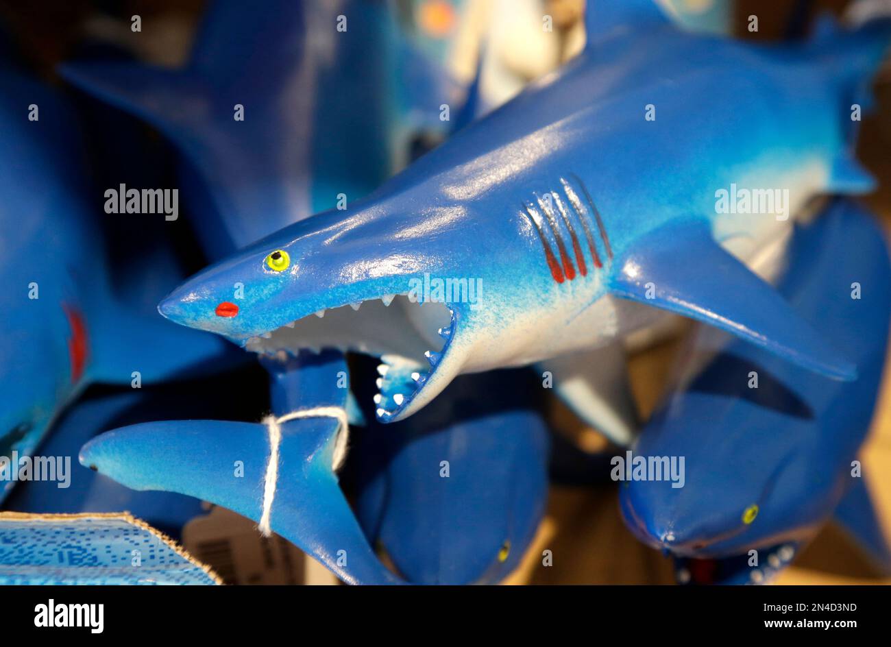 In this July 2, 2014 photo, a bin is filled with plastic toy sharks in ...