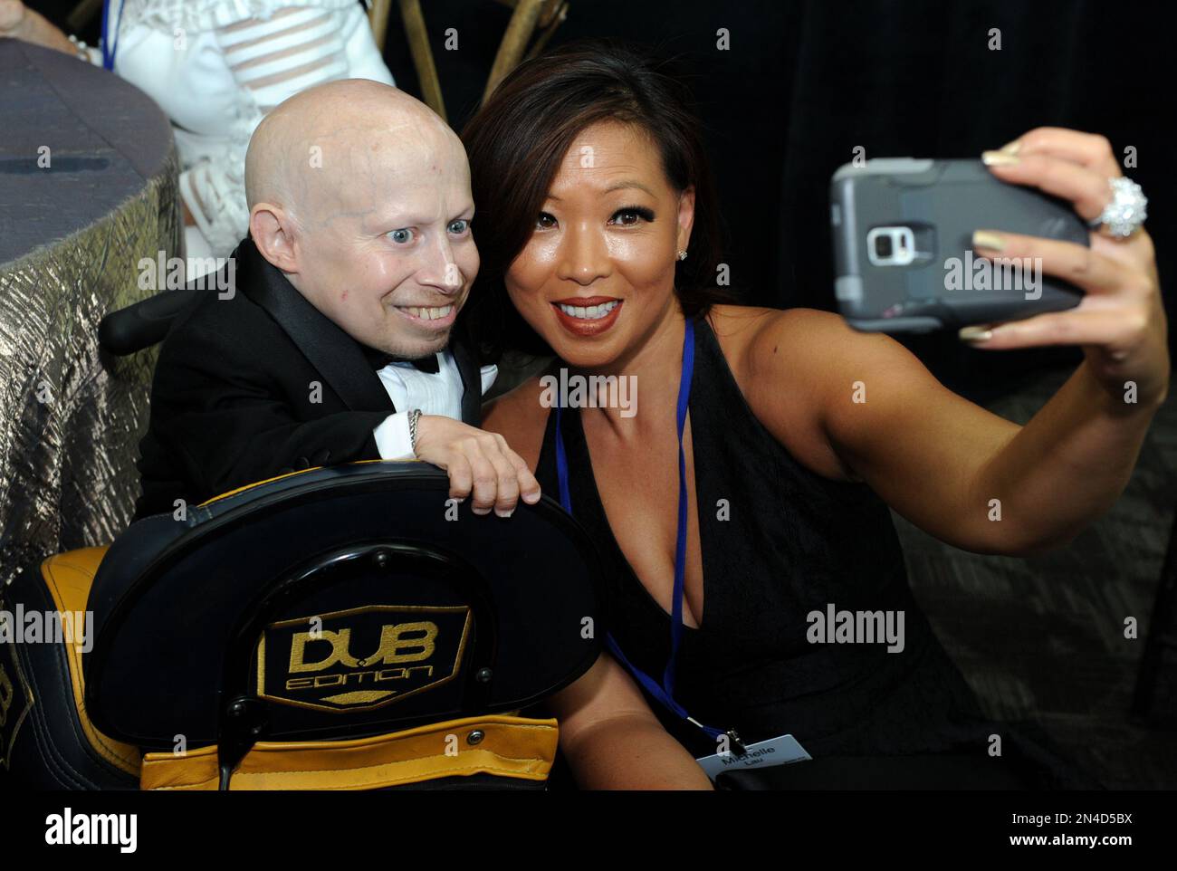 Poker player Michelle Lau takes a selfie with actor Verne Troyer at the ...