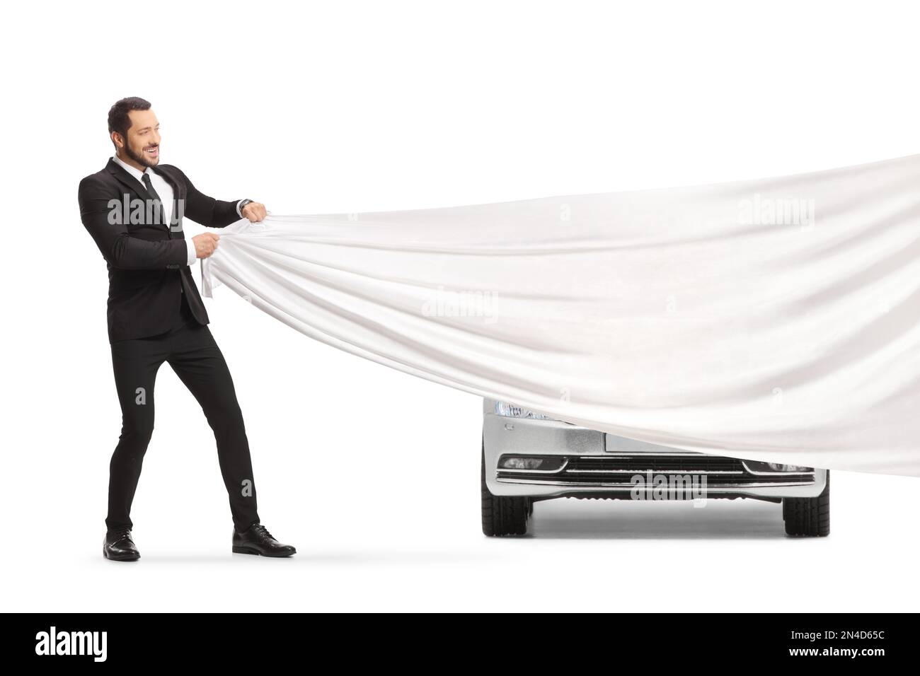 Businessman pulling a white piece of cloth in front of a new car ...