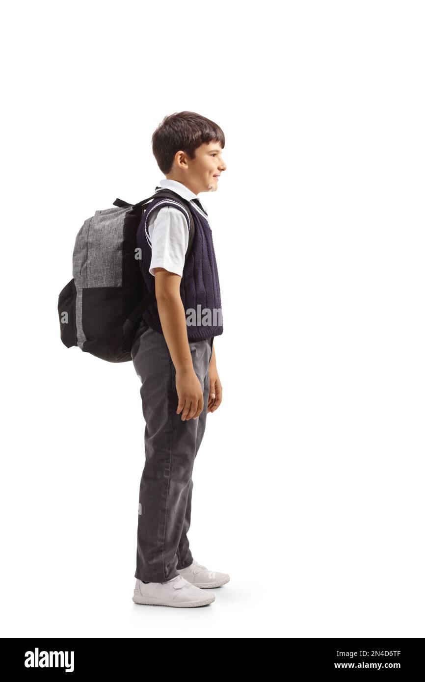 Full length profile shot of a boy in a school uniform carrying a ...