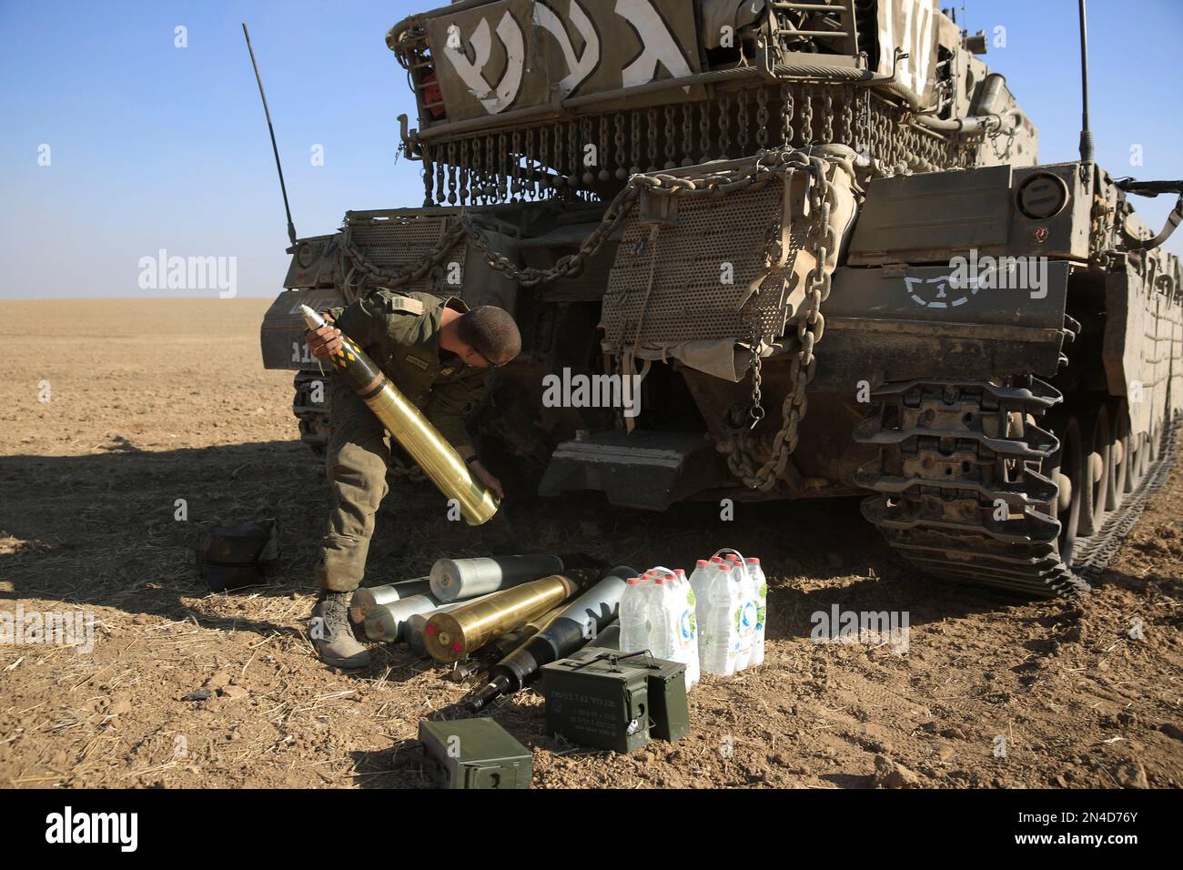 An Israeli soldier loads tank shells near the border of Israel and the ...