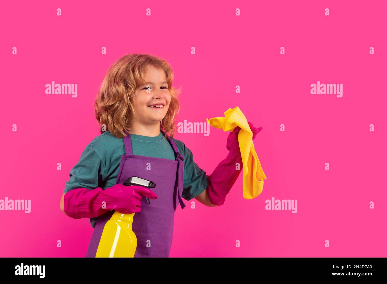 Studio portrait of child helping with housework, cleaning the house ...