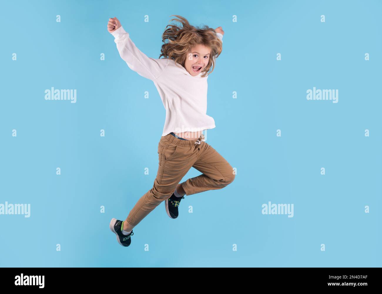 Boy jumping. Full size of kid boy have fun jump up isolated over blue ...