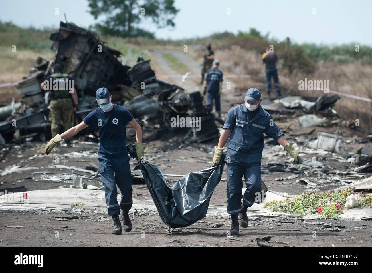 Ukrainian Emergency workers carry a victim's body in a body bag as pro ...