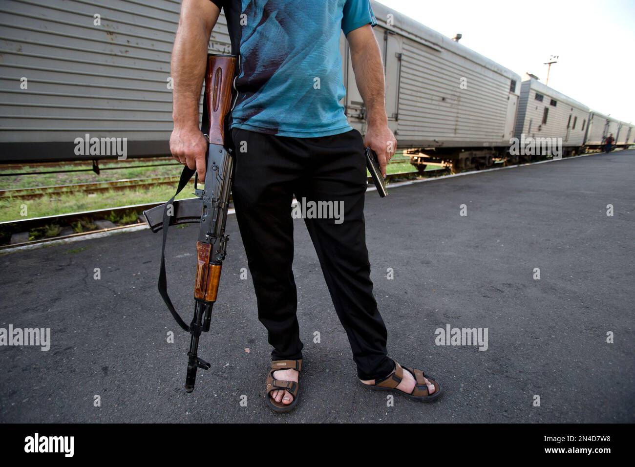 An armed pro-Russian rebel secures the area next to a refrigerated ...