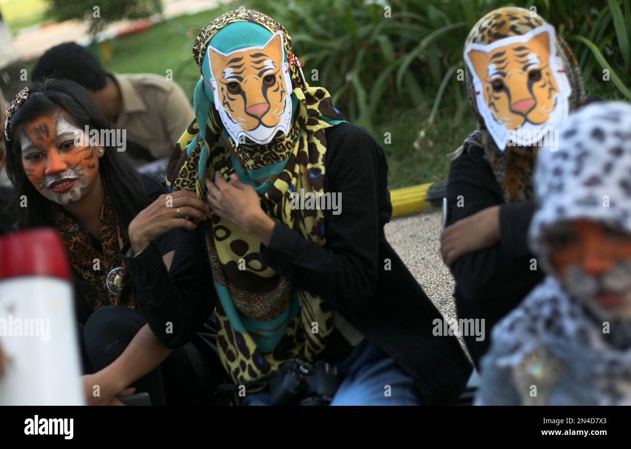 Indonesian students wear tiger masks during a rally calling for ...