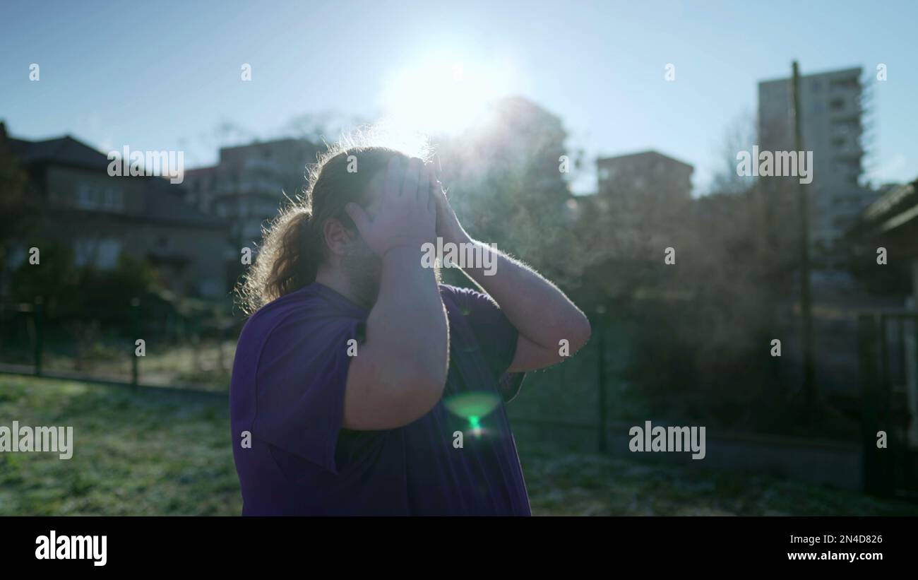Portrait of an upset angry person walking outside feeling regret for ...