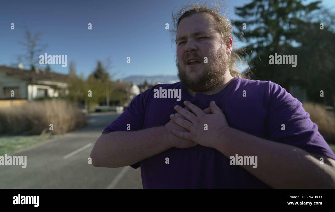 One young fat man having chest pain. Overweight person with panic ...