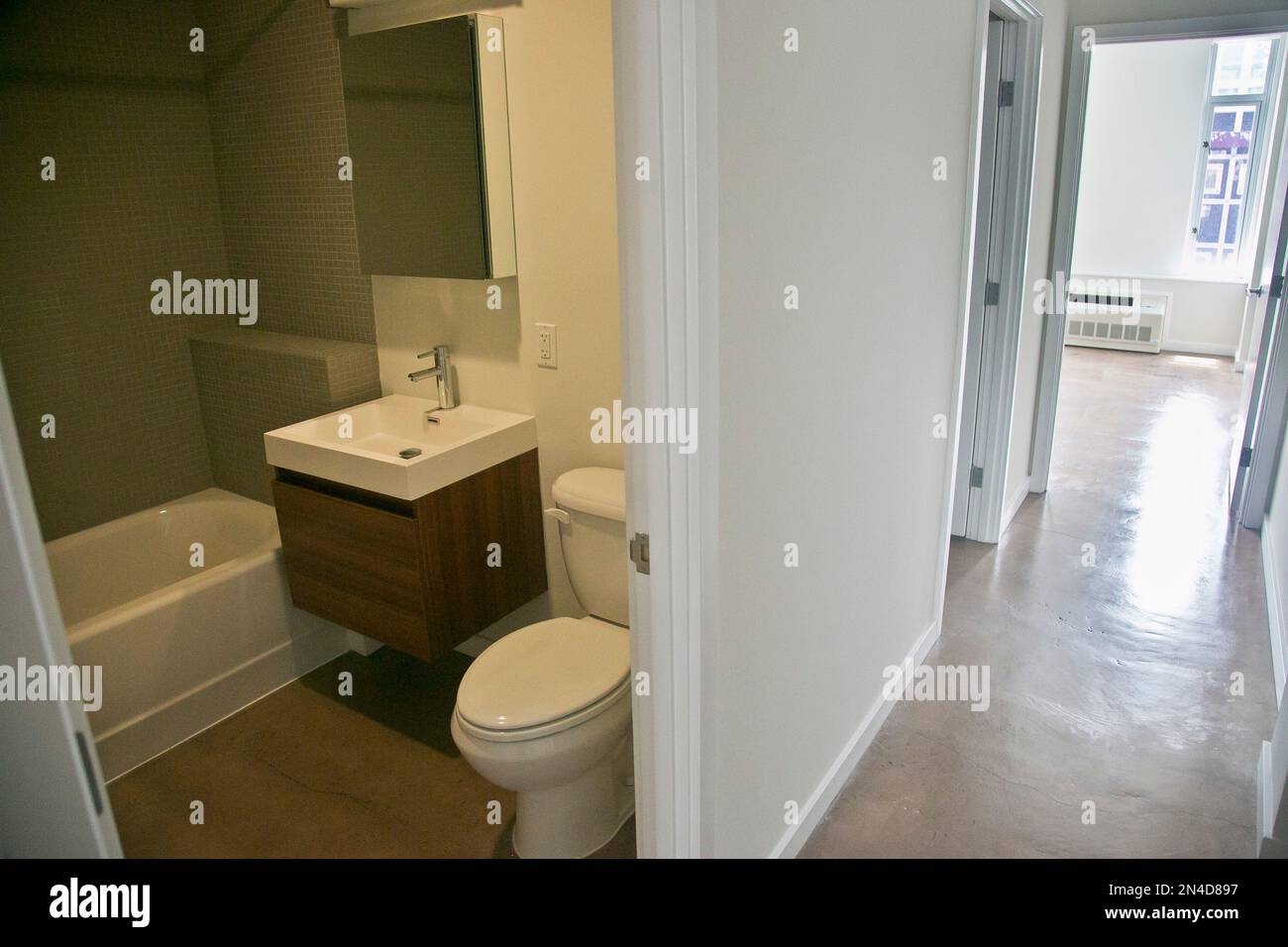 An interior view shows a bathroom along a passage way in a seven-story ...