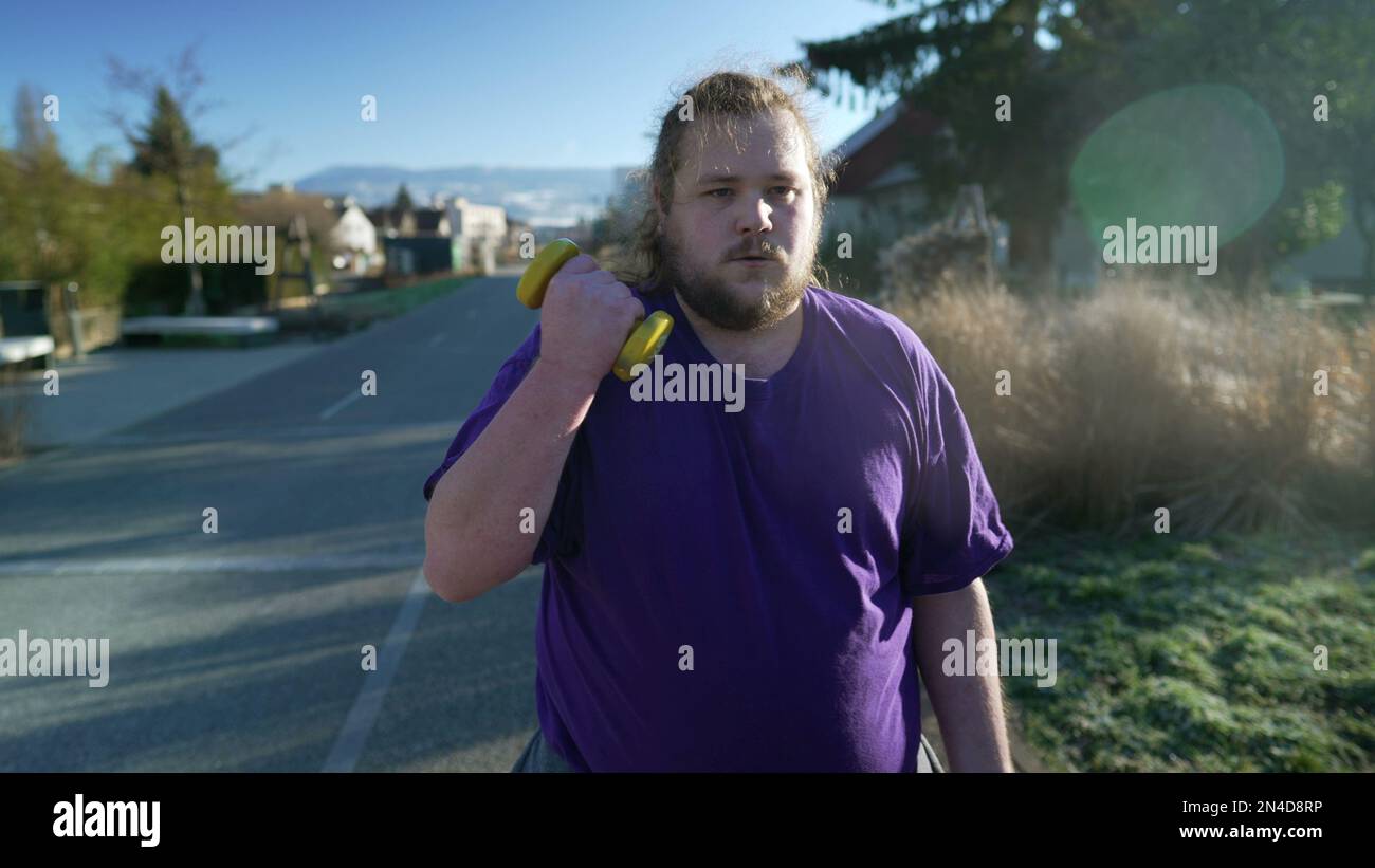 A young fat man getting back into shape building strength. Motivational ...
