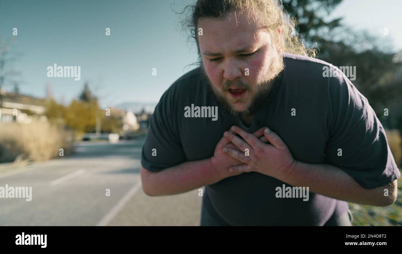 Person suffering from physical pain outdoors. Man unable to breath with ...