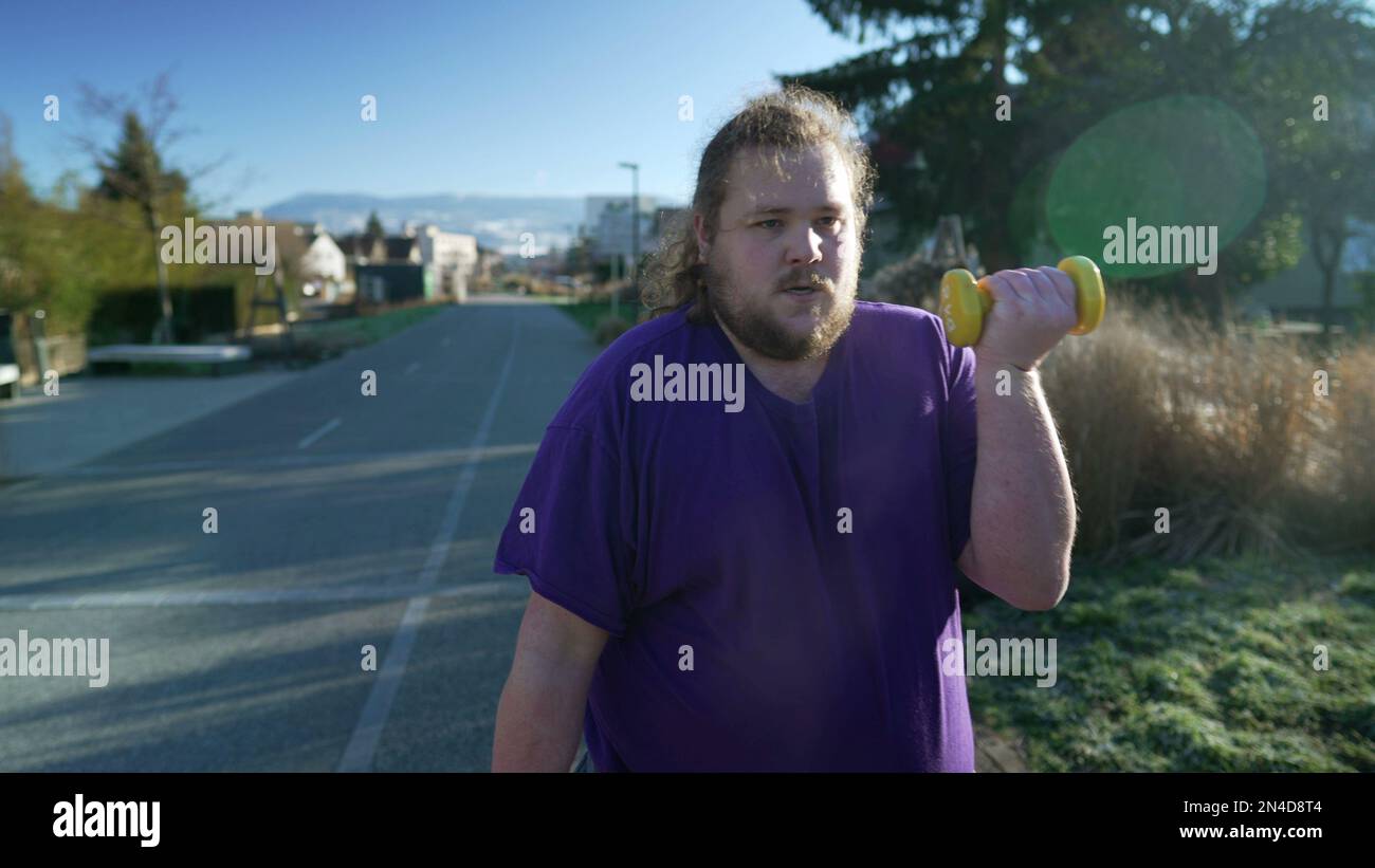 A young fat man getting back into shape building strength. Motivational ...