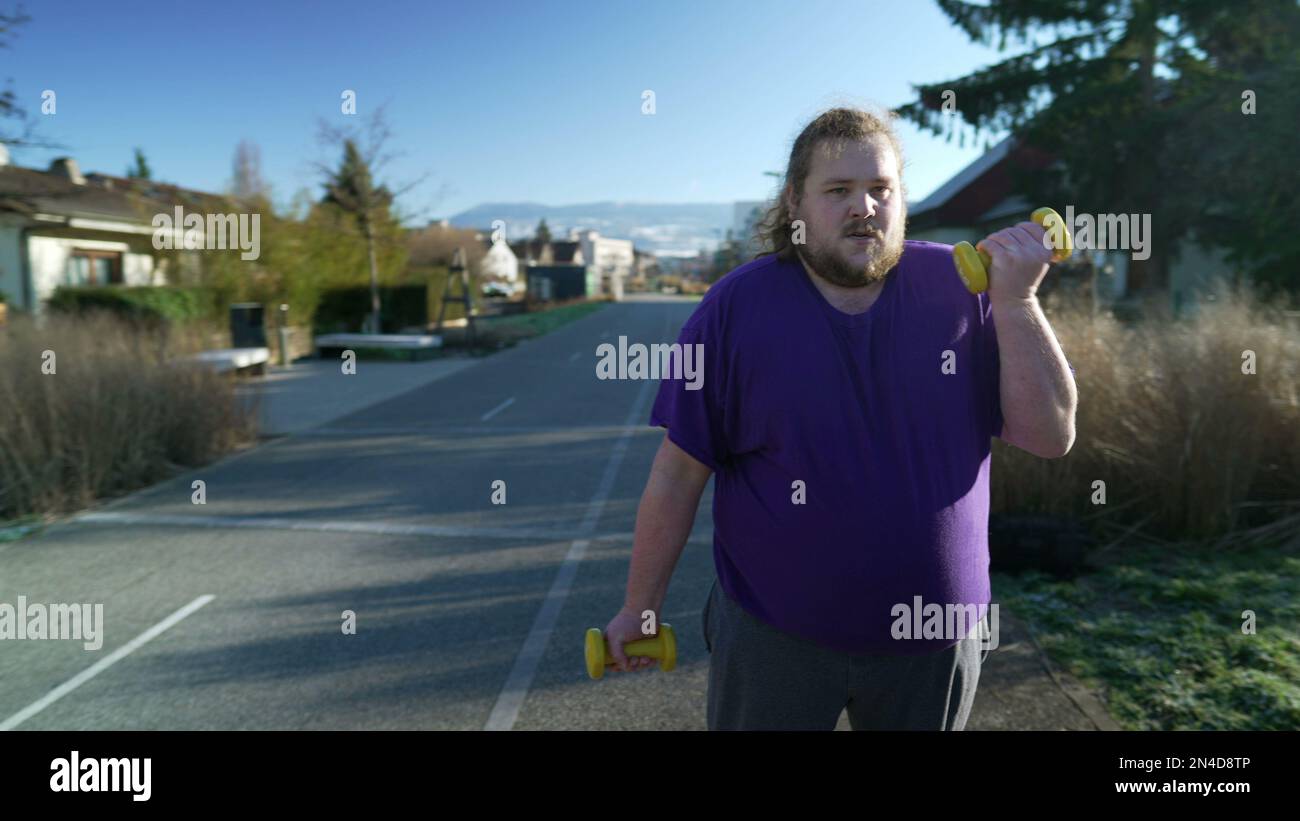 A young fat man getting back into shape building strength. Motivational ...