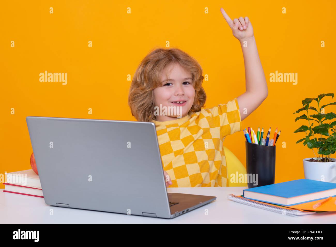 School kid holding index finger up with great new idea. School child ...