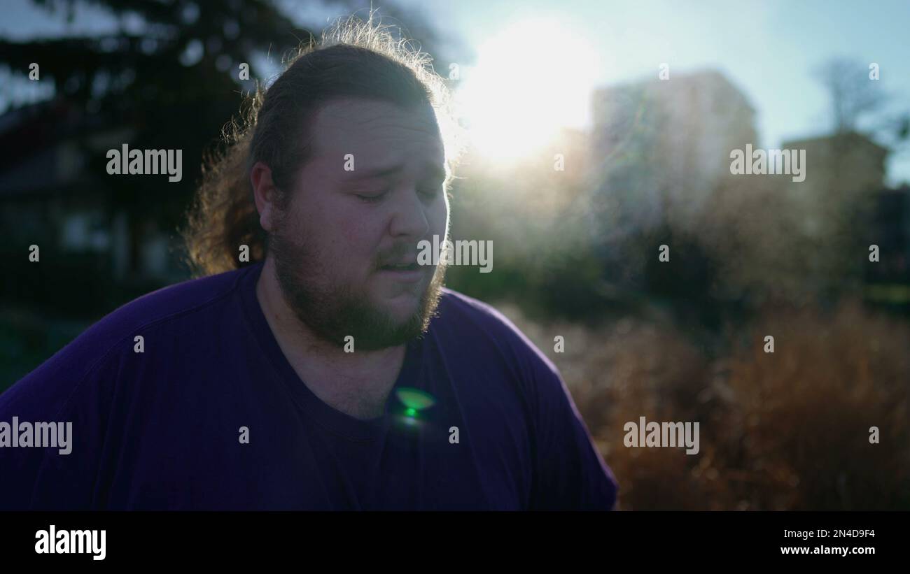 One chubby man taking a deep breath wtih vapor steam in the cold ...