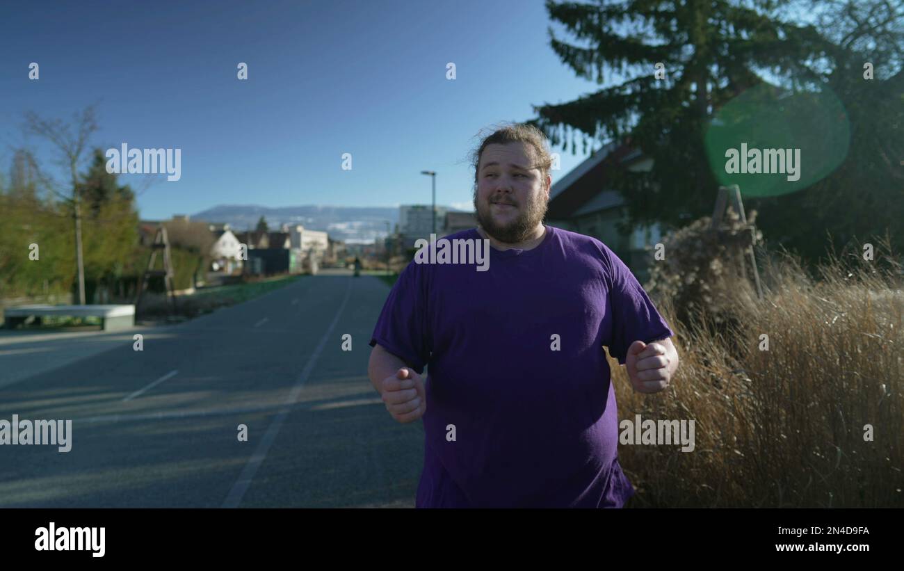 One happy fat man dancing and singing walking outside in street. A ...