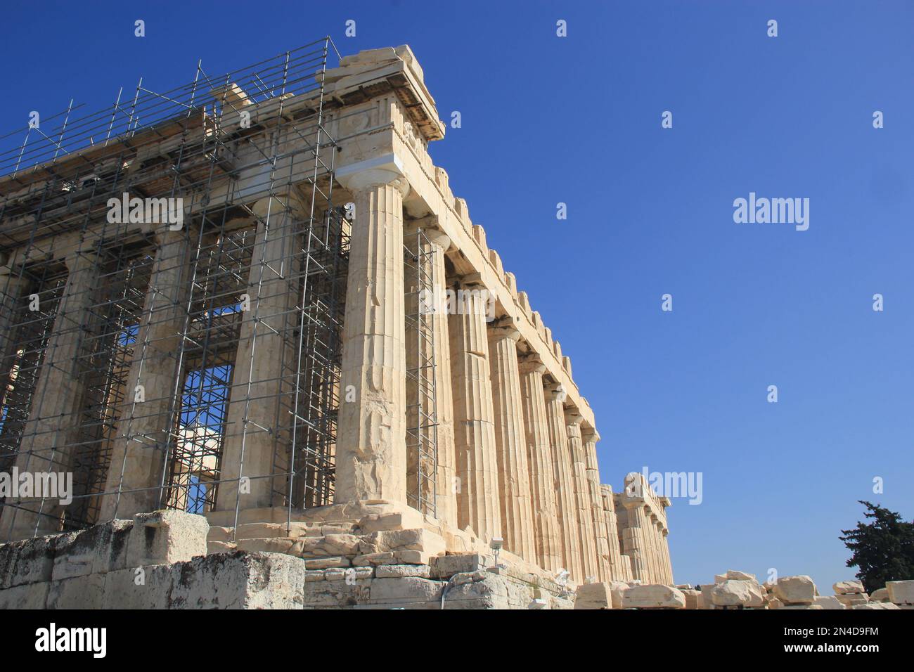 A side view of the Parthenon temple under a blue sky in Athens, Greece Stock Photo - Alamy