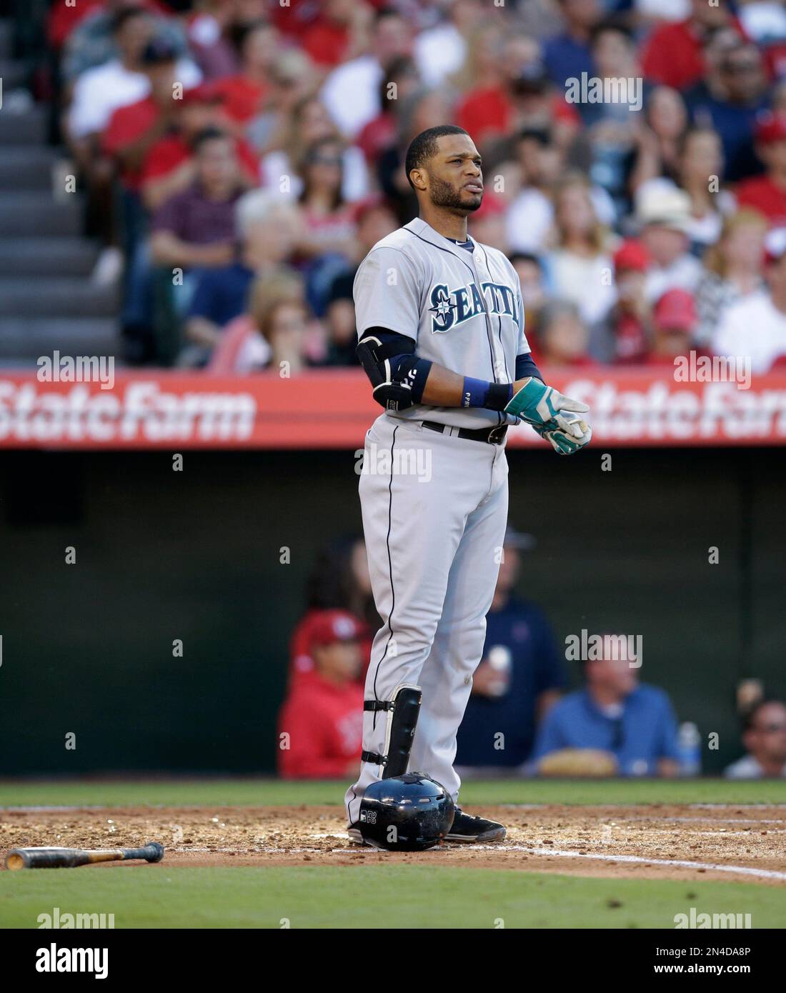 Seattle Mariners' Robinson Cano takes off his gloves after striking out ...