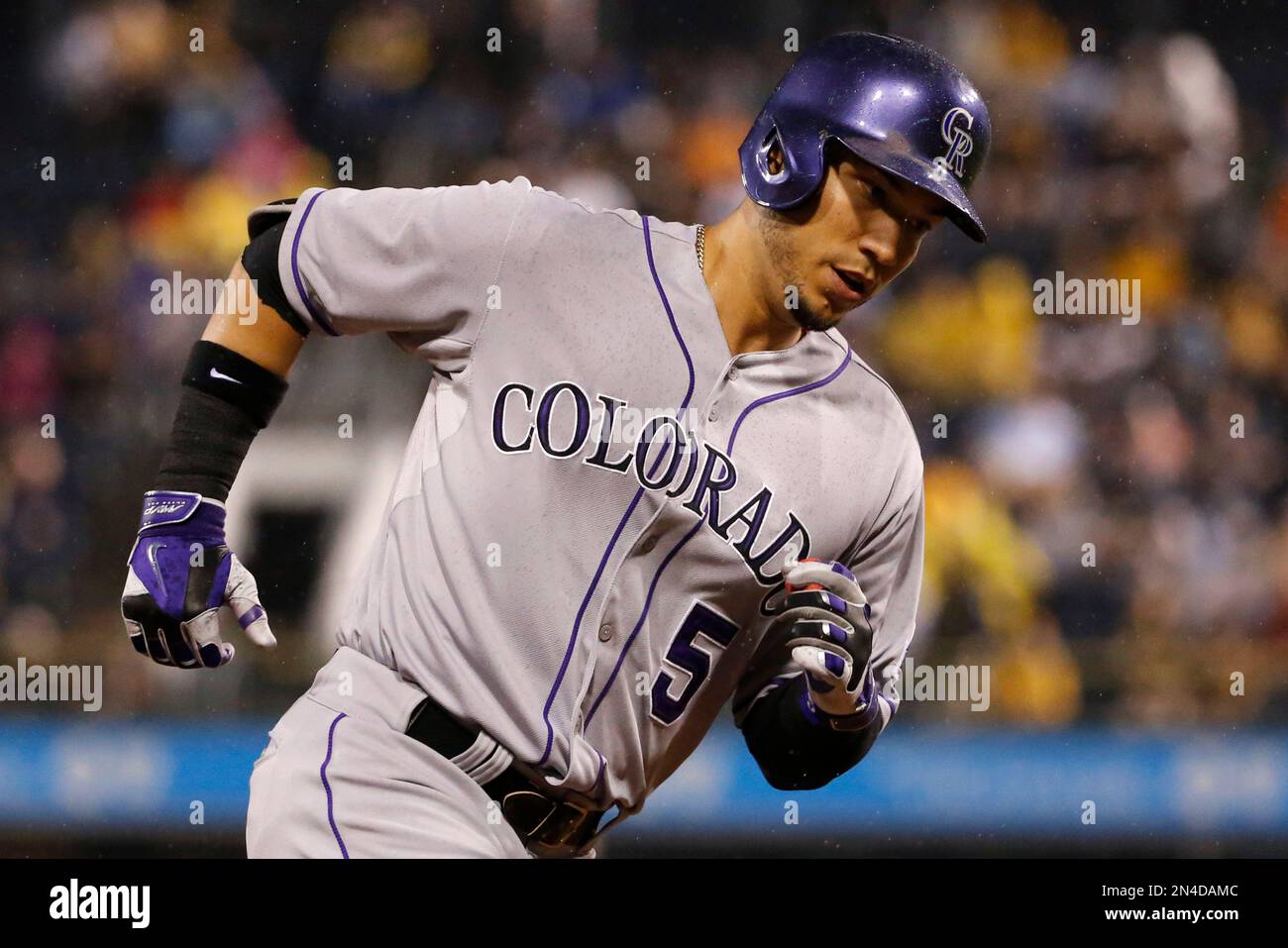 Colorado Rockies' Carlos Gonzalez (5) rounds third after hitting a two ...