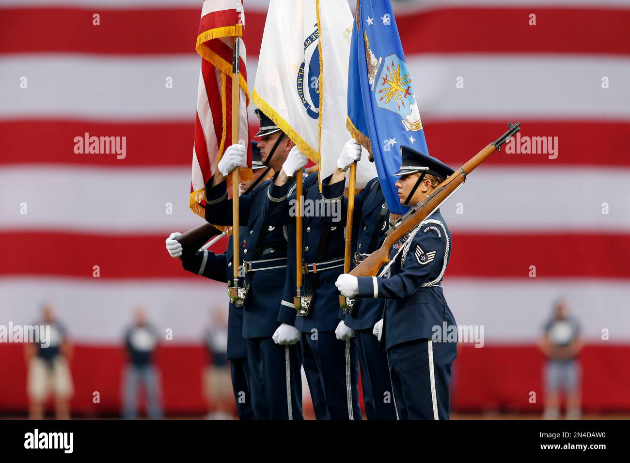 A military color guard stands on the field at Fenway Park for the ...