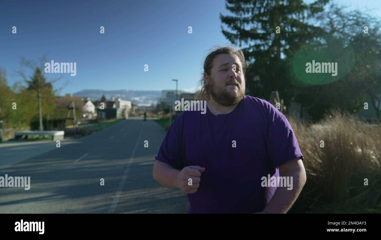 One happy fat man dancing and singing walking outside in street. A ...