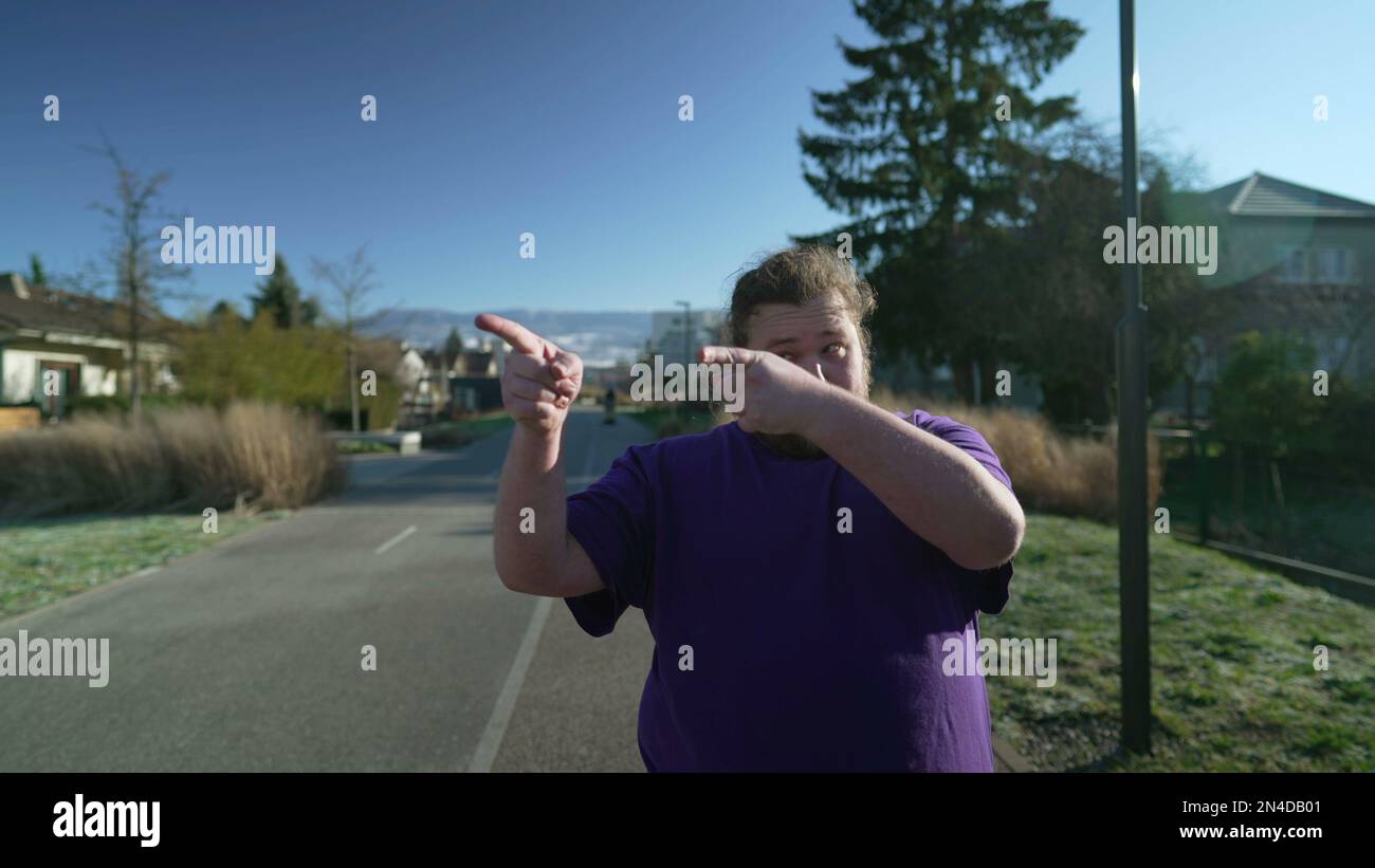 One happy fat man dancing and singing walking outside in street. A ...