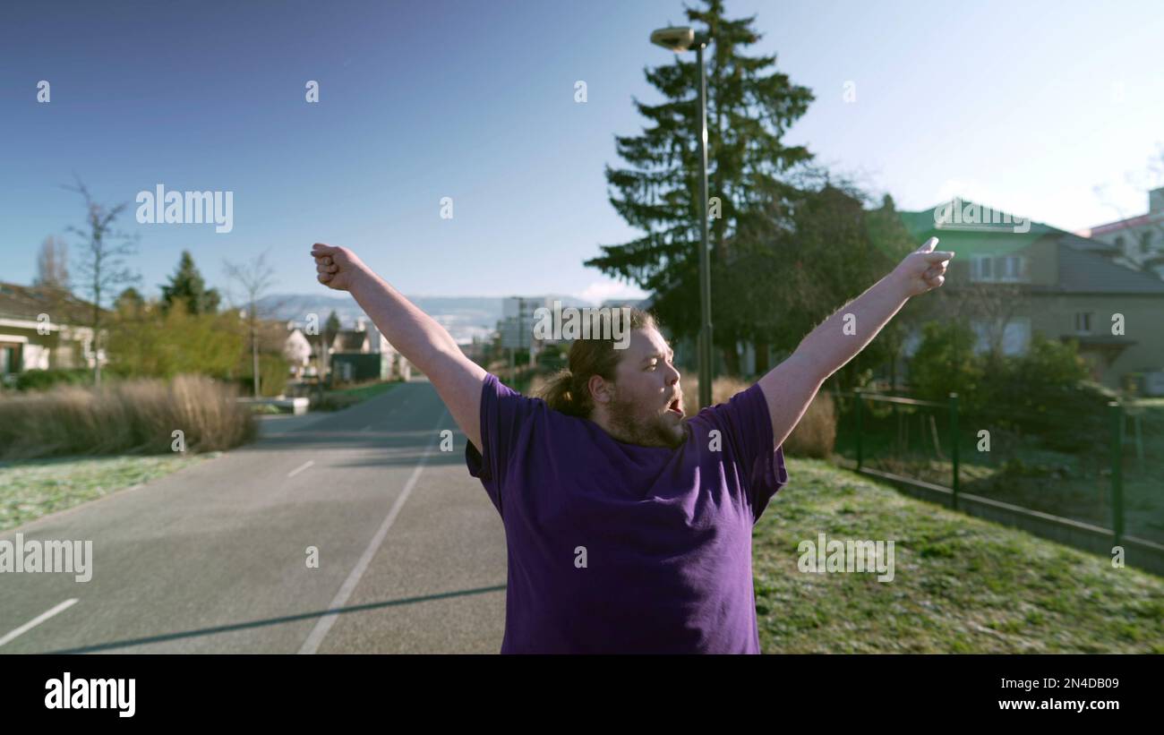 One happy overweight man dancing outside in street. A fat Person ...