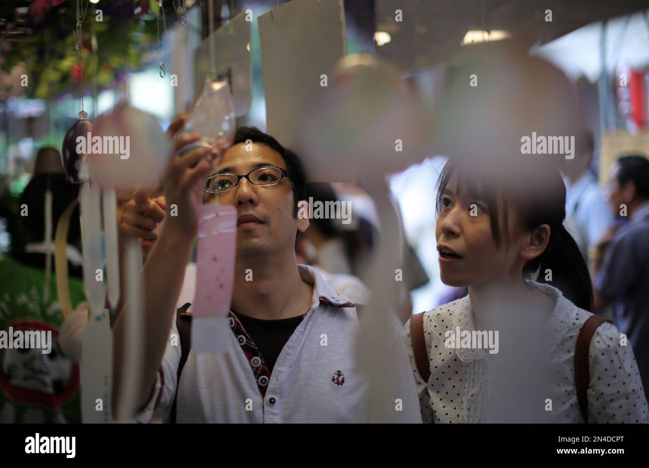 Visitors shop traditional wind chimes at the wind chimes market at ...
