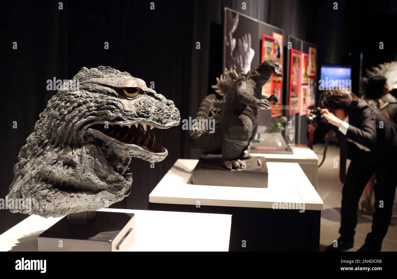 Statues of Godzilla are on display during a press preview at Godzilla ...