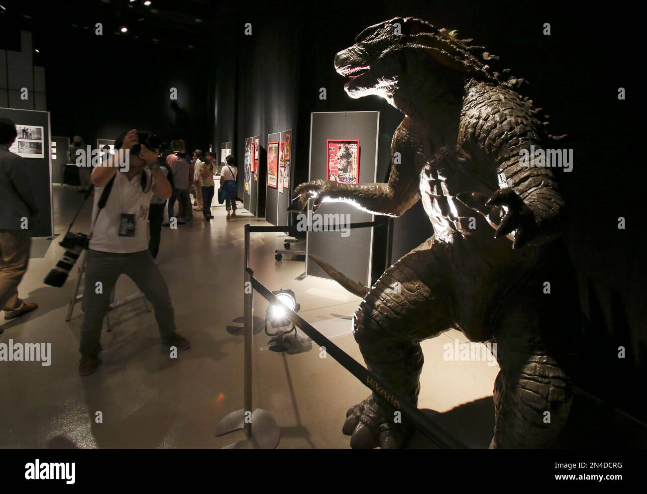 A statue of Godzilla is on display during a press preview at Godzilla ...