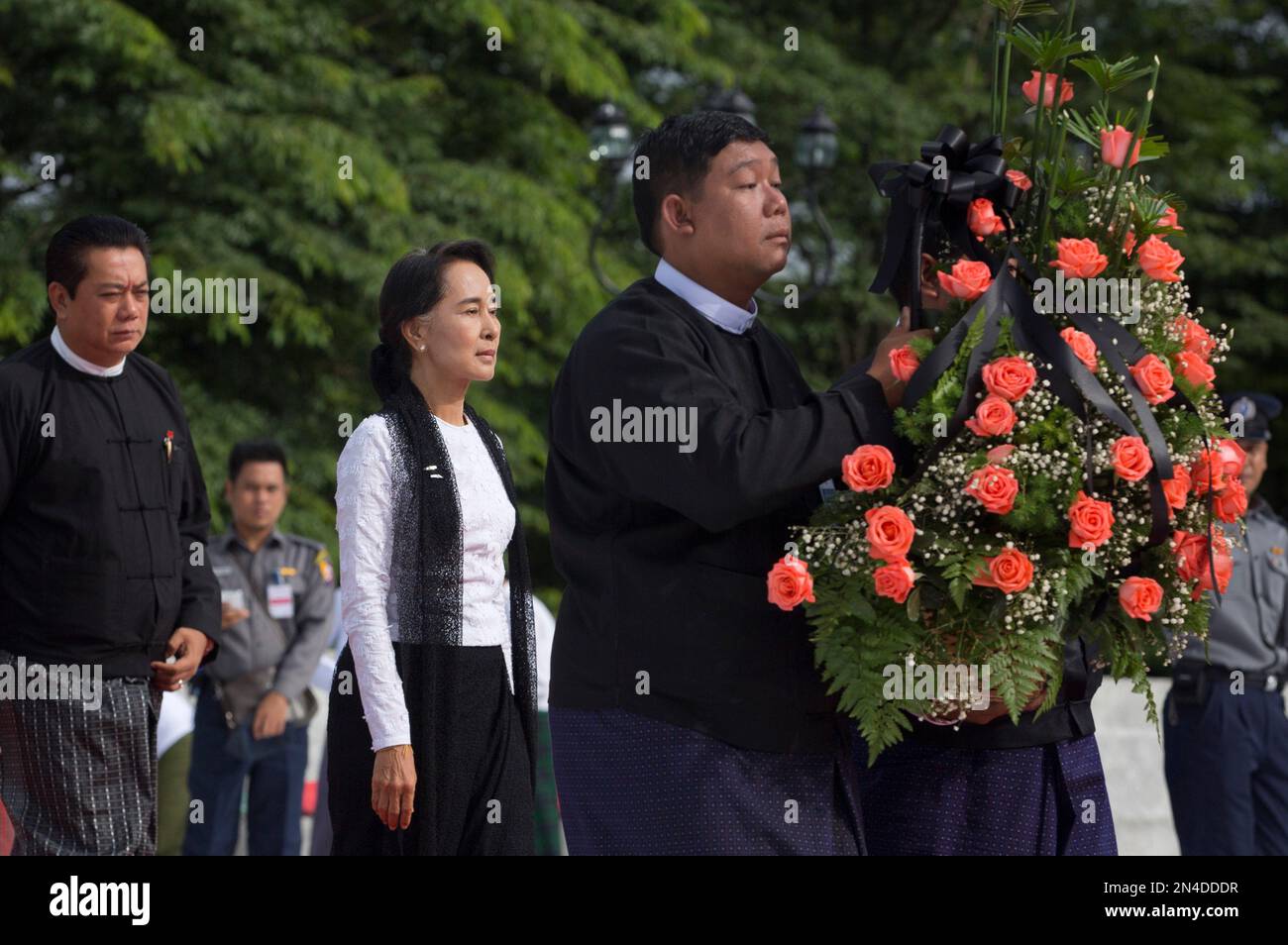 Myanmar opposition leader Aung San Suu Kyi, white blouse, walks behind ...