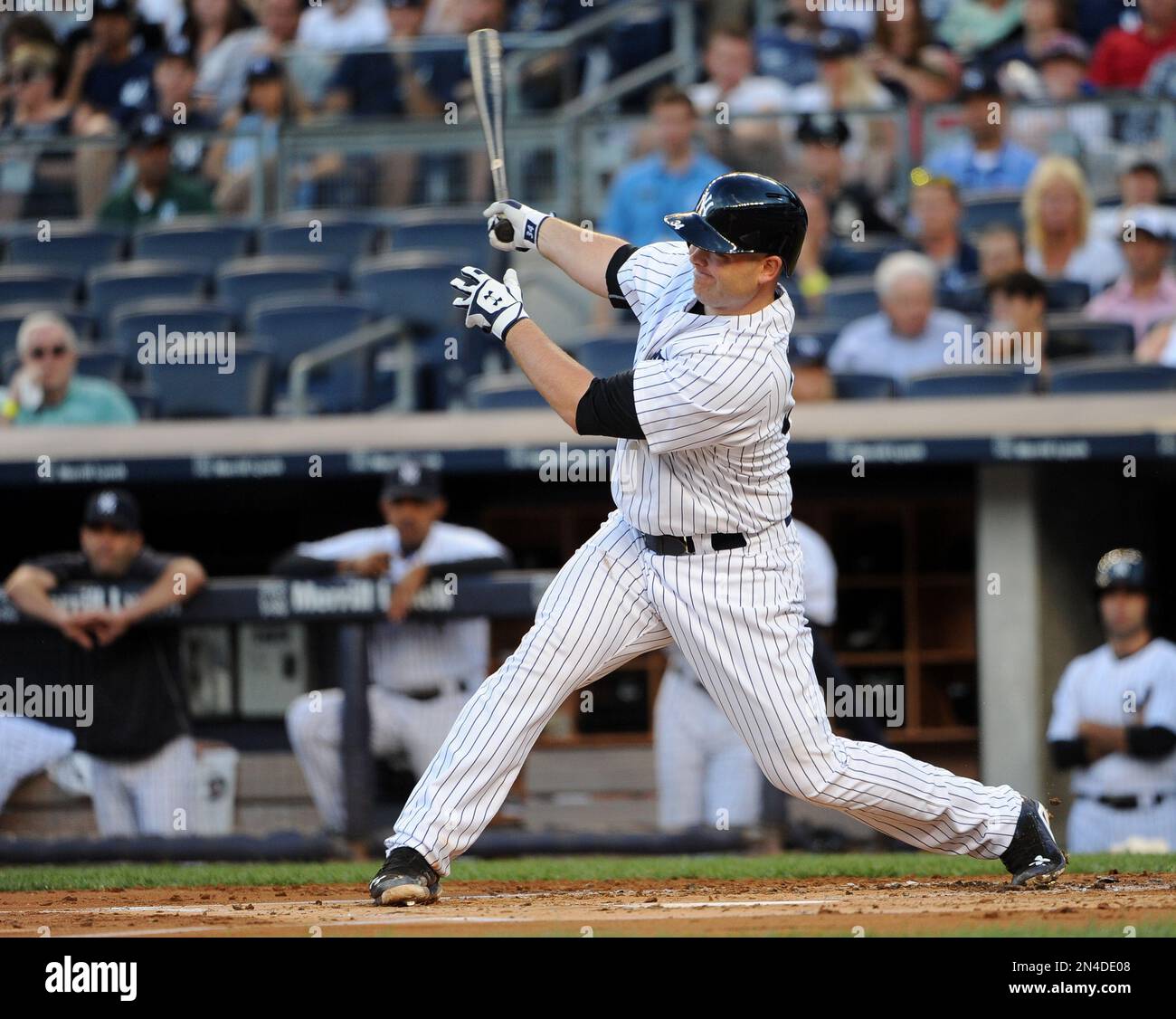 New York Yankees' Brian McCann follows through on an RBI double off of ...